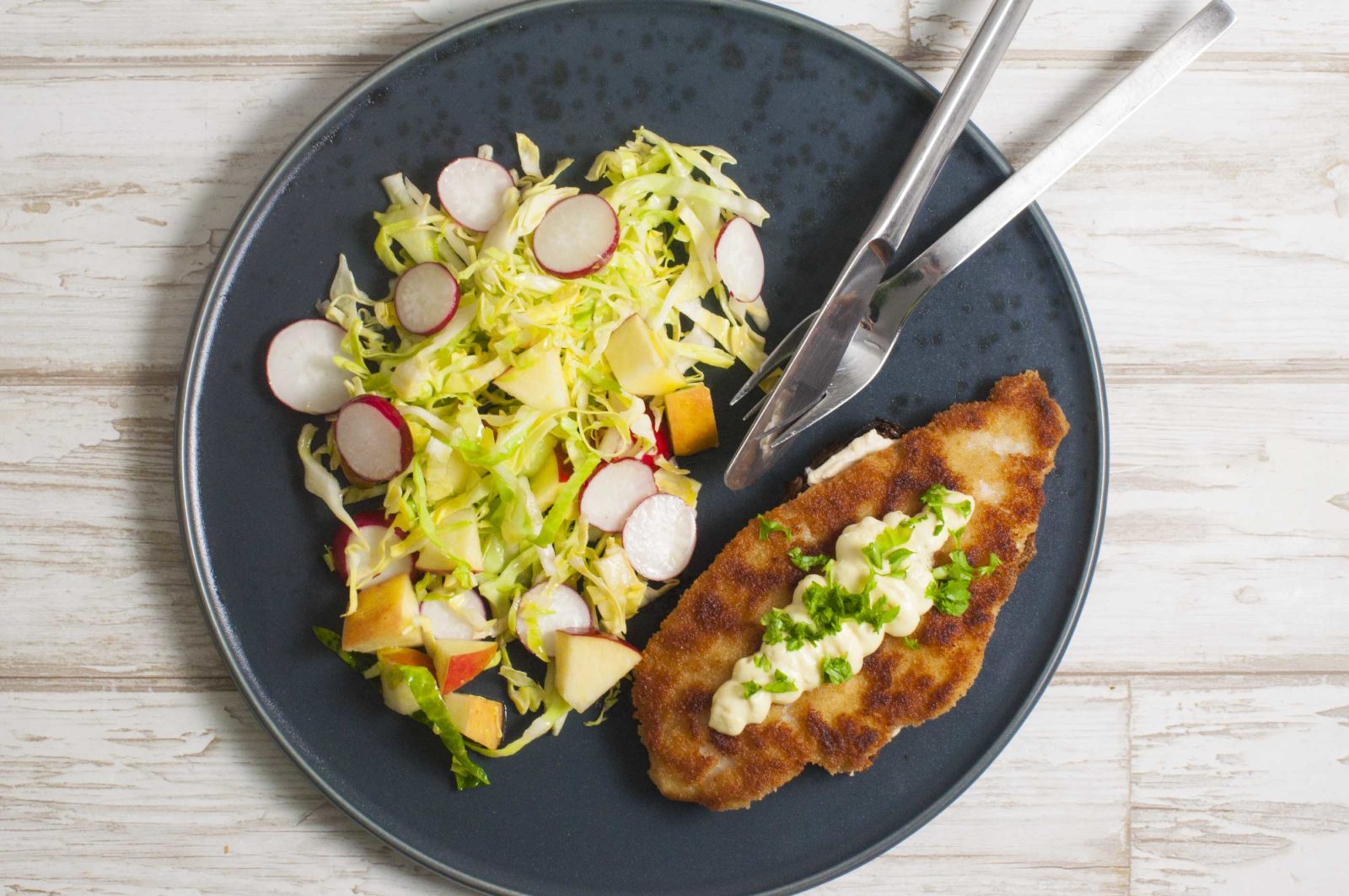 Homemade fish fillet with tartar sauce and pointed cabbage salad