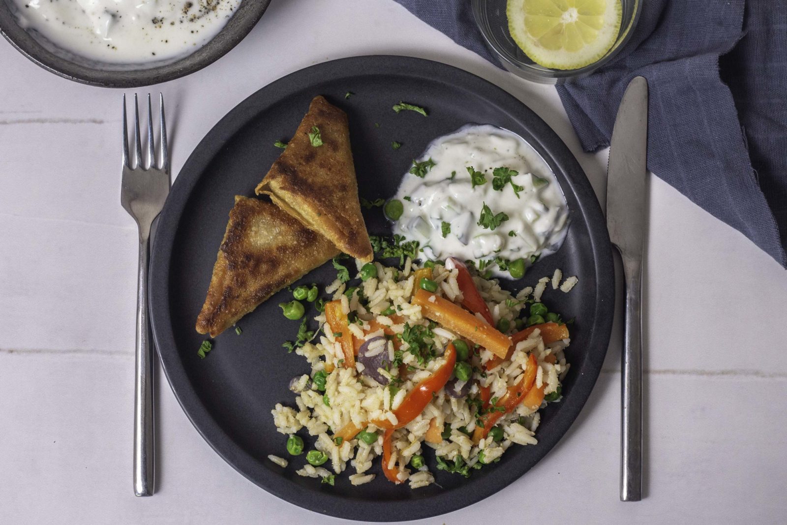 Homemade samosas with rice salad and a quick raita