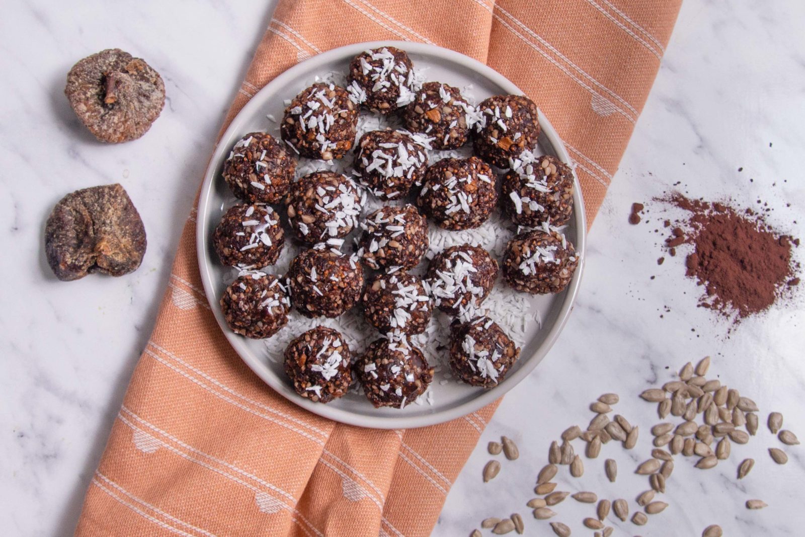 Fig balls with cocoa powder, sunflower seeds and coconut