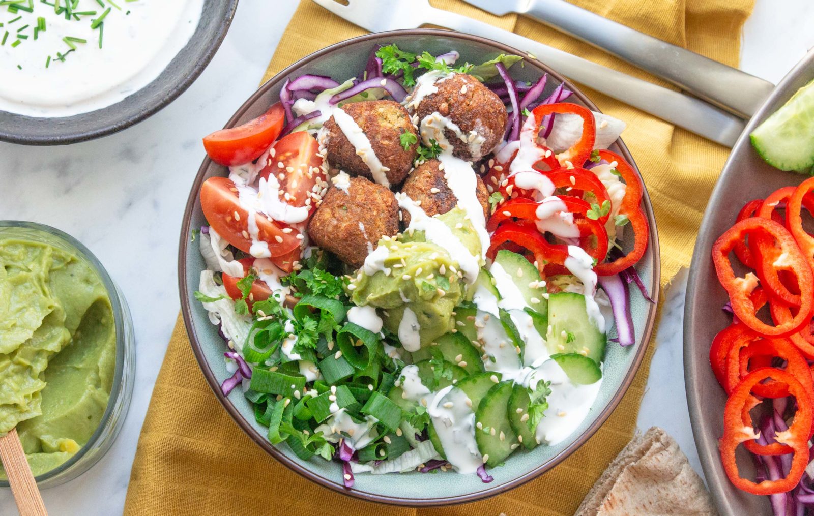 Self-assembly falafel bowls with veggies and pitabreads